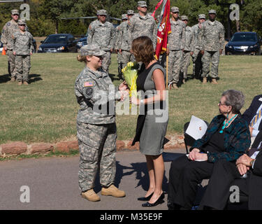 Flowers are presented to Mrs. Wilham, wife of outgoing commander Col ...