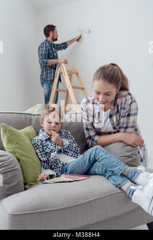 happy family with color palette moving to new home Stock Photo - Alamy