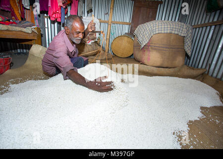 Abu syed ali, khoi (popped rice) making business he is holding them 34 ...