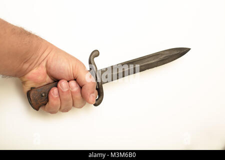Hand holding short melee weapon in close up view against white ...