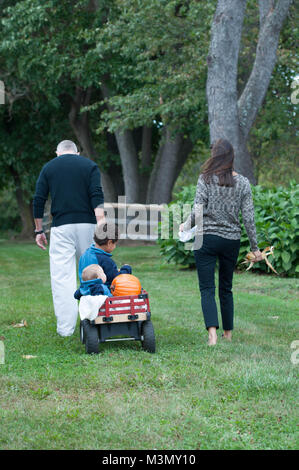 Parents Pulling Children in a Wagon Stock Photo - Alamy