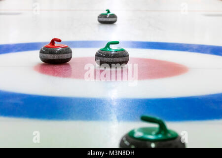 Curling - a granite stone on the ice field Stock Photo - Alamy