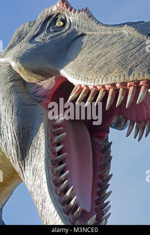 Allosaurus dinosaur model in a prehistoric park with open mouth showing ...