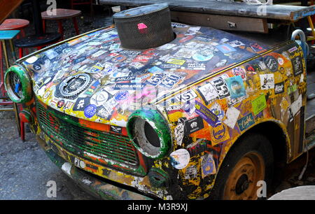 Trabant covered in graffiti and stickers on display at the Szimpla kert ...