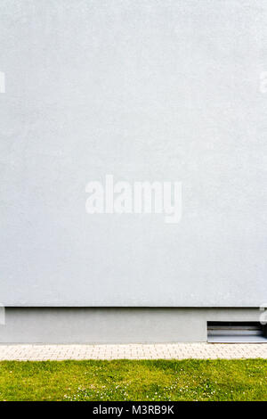 Modern light blue plaster wall with small basement window Stock Photo ...