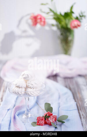 Marshmallows on plate on light background Stock Photo - Alamy