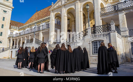 Coimbra University students with traditional black capes strolling ...