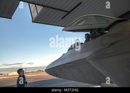 Senior Airman Christopher Sauter talks with Capt. Dustin Hardwick as ...
