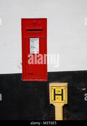 Yellow fire hydrant concrete marker post Stock Photo - Alamy
