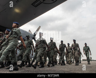 Members of the Gabonese military march under the wing of a U.S. Air ...