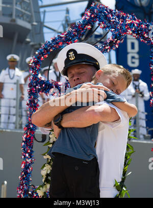 A Sailor is promoted to chief during a homecoming for the guided ...