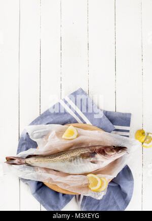 Uncooked Raw cod whole fish on marble board with thyme. Isolated on ...