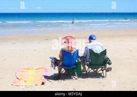 Adelaide, Australia. 13th Feb 2018. A Beachgoer sunbathing at Glenelg ...