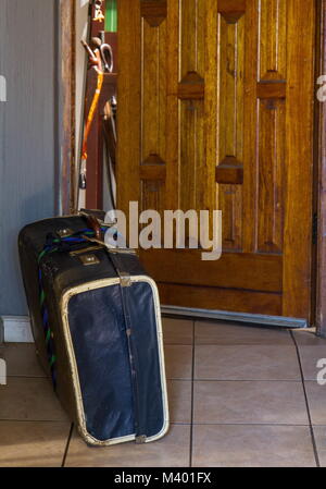 Dilapidated retro cardboard suitcase tied closed with a tie in front of ...
