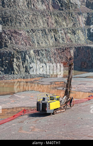 Drilling machine in open cast mining quarry Stock Photo - Alamy