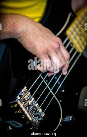Bass guitar musician playing close up black Stock Photo - Alamy