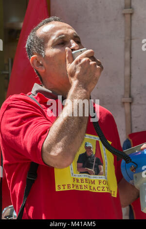 A man leads the chanting for the release of Scottish leftist Steve ...