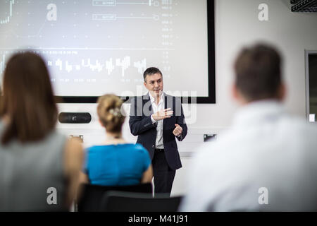 Businessman leading a training conference Stock Photo - Alamy