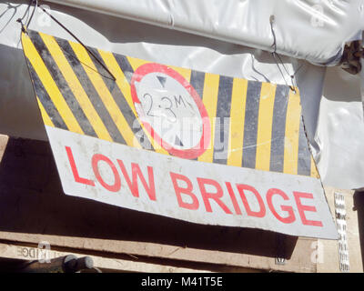 sign warning of height restrictions of low bridge ahead Stock Photo - Alamy