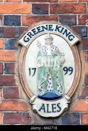 Ceramic sign for the Greene King brewery on the wall of a pub in London ...