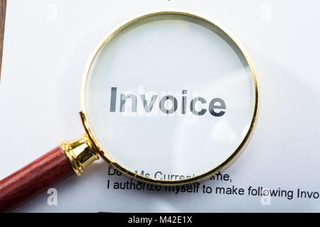 Close-up Of An Invoice Text Seen Through Magnifying Glass Stock Photo ...