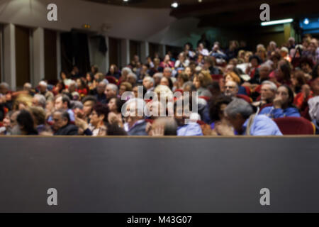 A full theatre audience sitting in auditorium watching a play ...