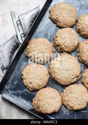 High angle shot of freshly baked cinnamon roll buns and a metallic ...