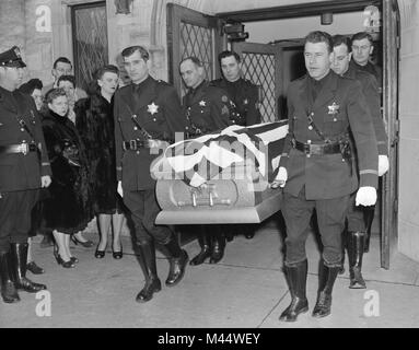 Police Officers carry the casket in during the start of a funeral for ...