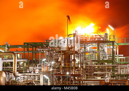 refinery - chemical factory at night with buildings, pipelines and ...