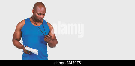 Composite image of fit trainer checking his stopwatch Stock Photo - Alamy