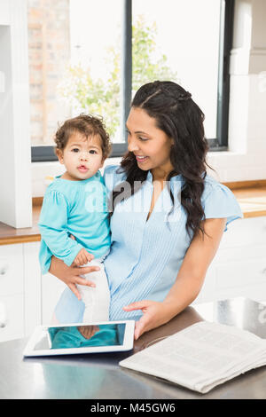 Sweet smiling girl using tablet pc outdoor Stock Photo - Alamy