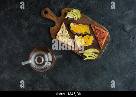 Breakfast with snacks and tea on wooden table Stock Photo - Alamy