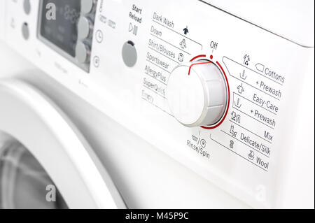 Closeup of white modern washing machine control panel dials and buttons ...