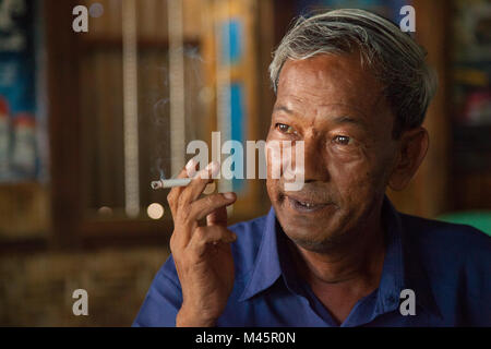 Local burmese man smoking cigarette in Myanmar Stock Photo - Alamy