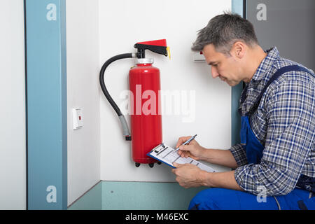 checking a fire extinguisher using clipboard Stock Photo - Alamy