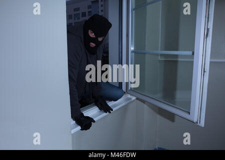 Intruder breaking into a house Stock Photo - Alamy