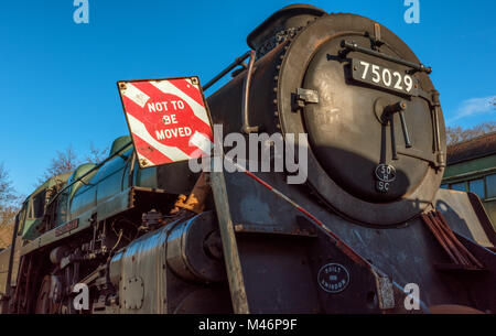 Old broken down steam train engine and tender being restored in a ...