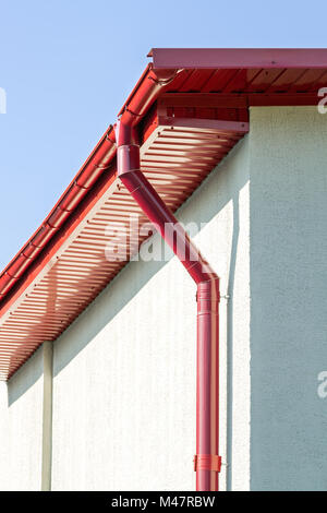 Roof gutter with house red metal tiled roof Stock Photo - Alamy