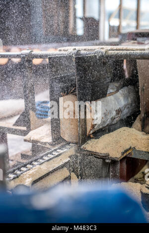 Machine sawing wood and sawdust flying Stock Photo - Alamy