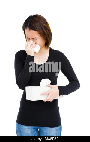 young asian woman blowing her nose with paper tissue Stock Photo - Alamy