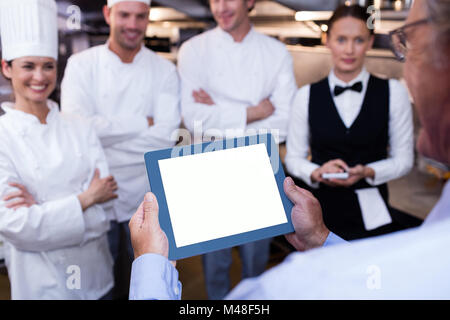 Restaurant manager briefing to his kitchen staff in the commercial ...