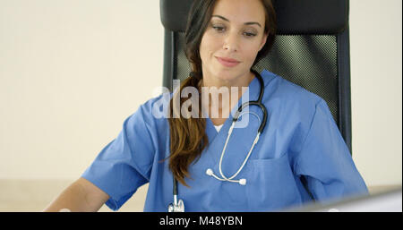 Young female physician places one hand on her face Stock Photo - Alamy
