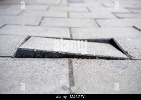 Loose paving slab on a pavement Stock Photo - Alamy