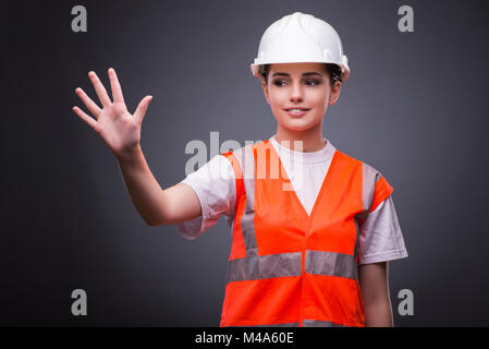 Cute construction worker pressing virtual buttons Stock Photo - Alamy