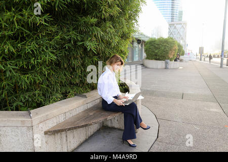 Statistician working outside with laptop and color diagrams Stock Photo ...