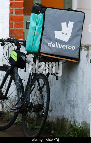 A Deliveroo food delivery box sits on the back of a bicycle as the ...
