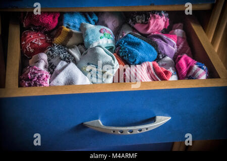 Socks in color drawer on white brick wall background Stock Photo - Alamy