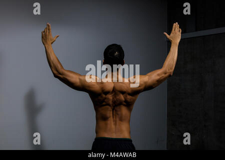 A male fitness model displays his back muscles Stock Photo - Alamy