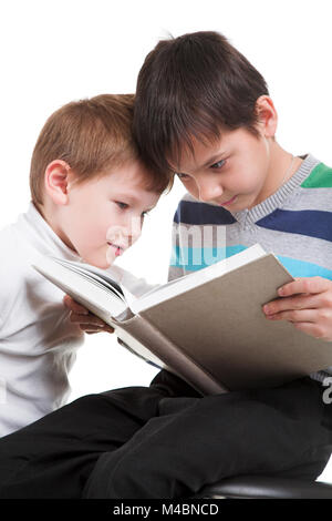 Two boys reading big book Stock Photo - Alamy