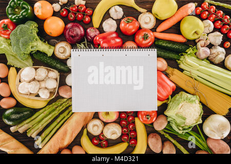 Empty notebook with vegetables on a wooden background Stock Photo - Alamy